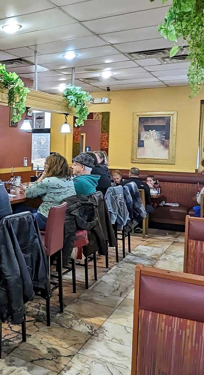 The warm tones and hanging greenery create an atmosphere where "just stopping for coffee" inevitably turns into "I'll have the full breakfast, please."