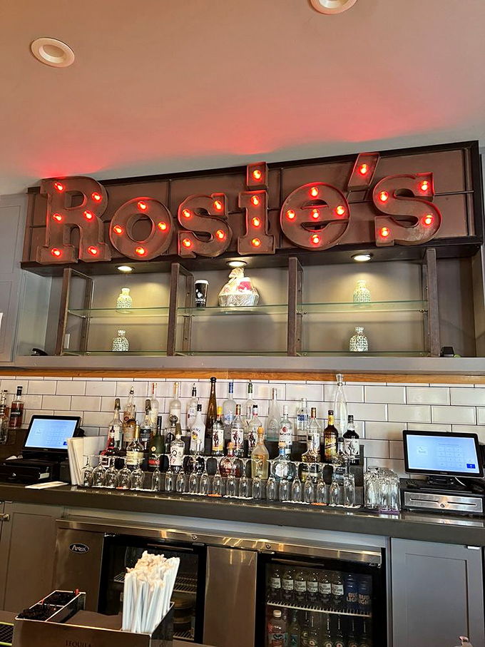 That illuminated "Rosie's" sign isn't just decor—it's a beacon for those seeking serious refreshment. Bar seating that promises good times ahead.