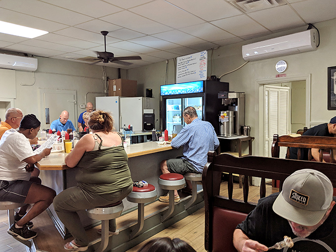 The counter where regulars perch like birds on a wire, exchanging local gossip and watching the breakfast ballet unfold behind the scenes.