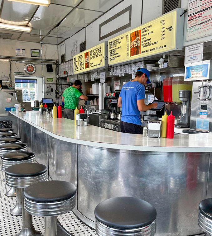 The stainless steel counter and classic stools create the perfect stage for burger enjoyment&mdash;where every seat feels like the best in the house.