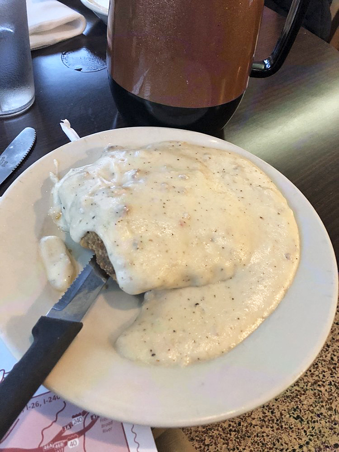 The counter service area at Clyde's, where regulars perch like birds on a wire, watching the choreography of small-town restaurant life unfold. 