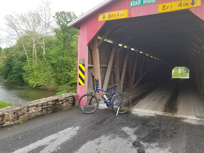 A cyclist's perfect pit stop. The bridge's wooden planks have supported everything from horse-drawn buggies to modern mountain bikes.