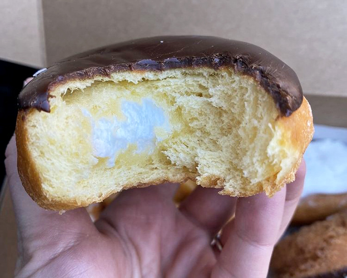The cross-section reveals the truth&mdash;this cream-filled donut contains more filling than some chain bakeries put in their entire display case.