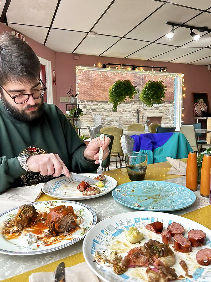 The universal language of good food: complete concentration as this diner navigates a table full of Polish delicacies.