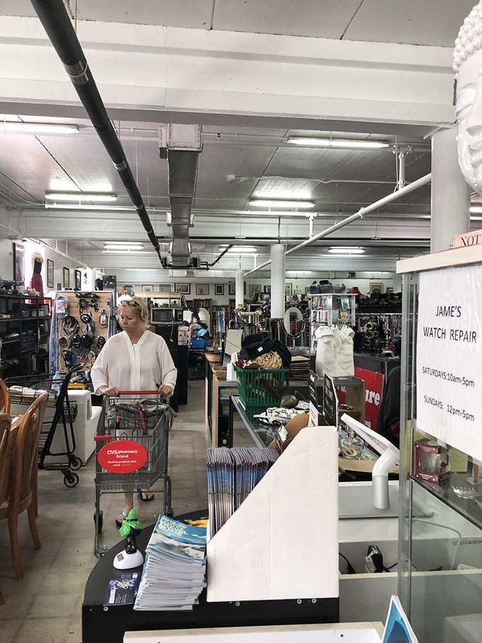 Treasure hunting in progress! This shopper navigates the aisles with the focused determination of someone who knows exactly what they're after.