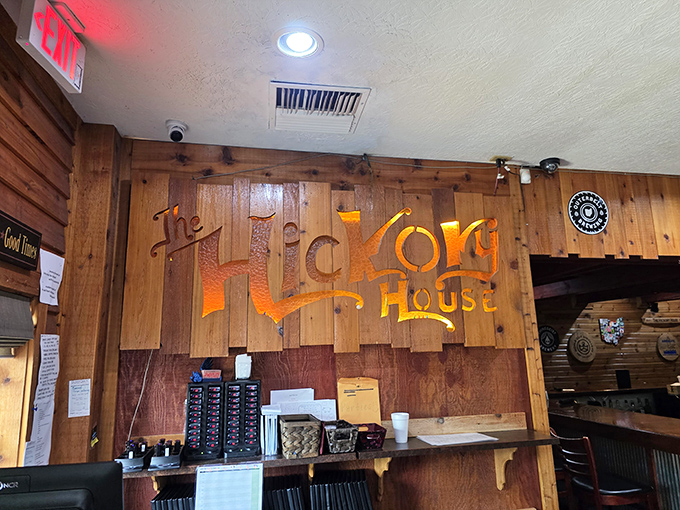 The illuminated wooden sign glows like a beacon of hope for the hungry – "The Hickory House" spelled out in letters that promise satisfaction.