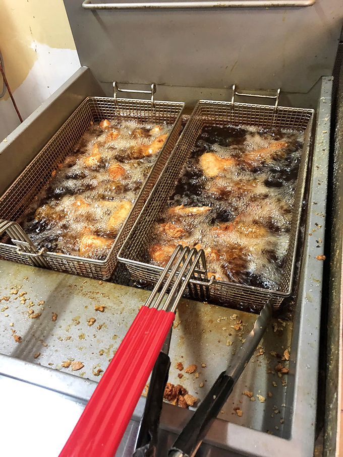 A behind-the-scenes glimpse at where the magic happens&mdash;bubbling oil transforming ordinary chicken into extraordinary culinary memories that keep locals coming back.