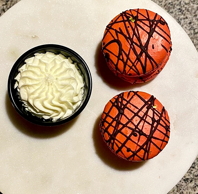 Desserts that make you want to start with the sweet stuff&mdash;vibrant macarons with artistic chocolate drizzles alongside a cloud of whipped cream.