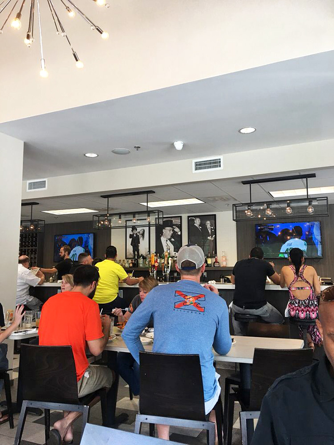 Where deli dreams come true&mdash;patrons enjoying the fruits of Top Hat's labor while sports play silently in the background. The perfect Florida afternoon.