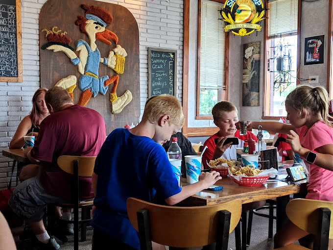 Family dining at its finest. The kids might be on devices, but those baskets of food have a way of bringing everyone back to the moment.