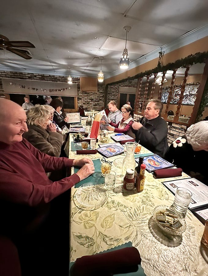 A gathering of diners enjoying the communal pleasure of a supper club meal. These tables have hosted countless celebrations, first dates, and regular Friday night rituals.
