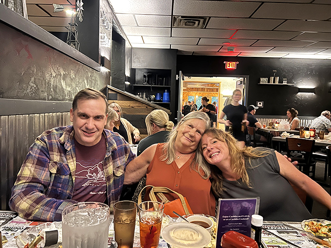 Happy diners sharing laughs and stories&mdash;the universal language of supper club camaraderie that makes every table feel like home.