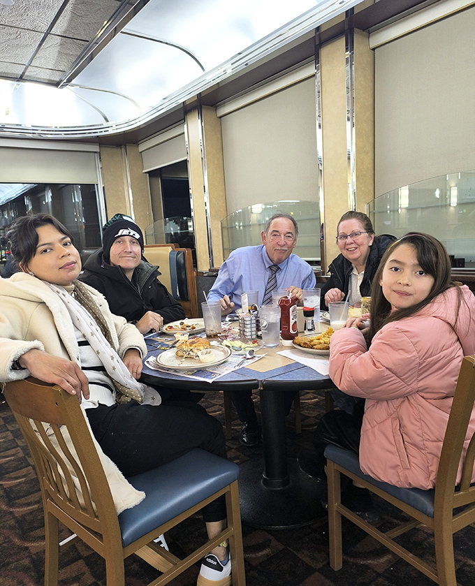 The image shows diners enjoying their meal at a table, capturing the communal experience that makes places like Trivet special gathering spots.