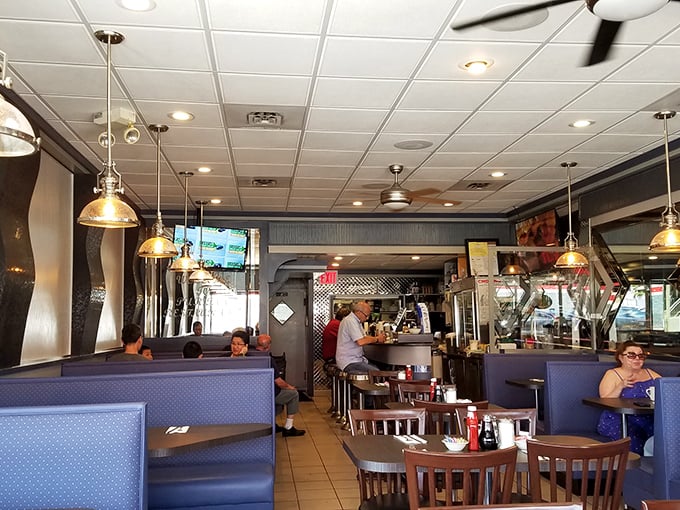 The dining room hums with the symphony of clinking forks, coffee cup refills, and conversations that make a neighborhood diner the true town hall.