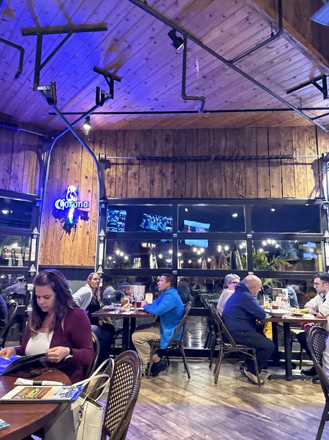 Evening dining under wooden beams and blue light&mdash;where conversations flow as smoothly as the drinks.