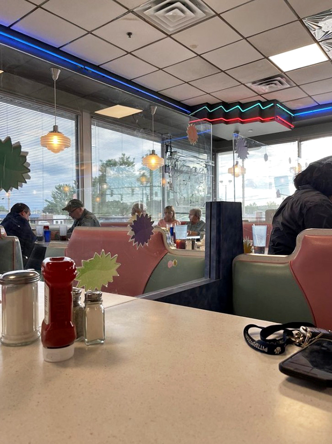 The quintessential diner experience: red ketchup bottles, salt and pepper shakers, and booths designed for lingering conversations.