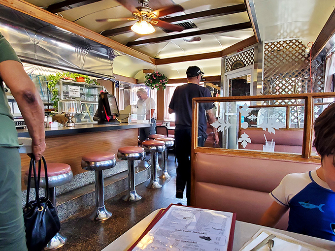 The diner's interior captures that perfect sweet spot between nostalgic comfort and timeless functionality. Those pink stools have stories to tell.
