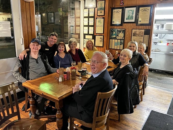 Happy diners gathered around a table of treasures&mdash;the universal expression of "we ordered perfectly" written across every smiling face.