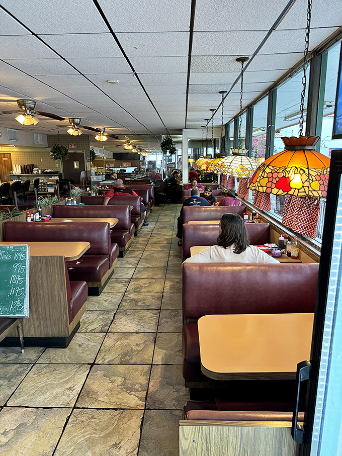 Tiffany-style hanging lamps cast a warm glow over burgundy booths where Miami locals have been solving the world's problems over breakfast since forever.