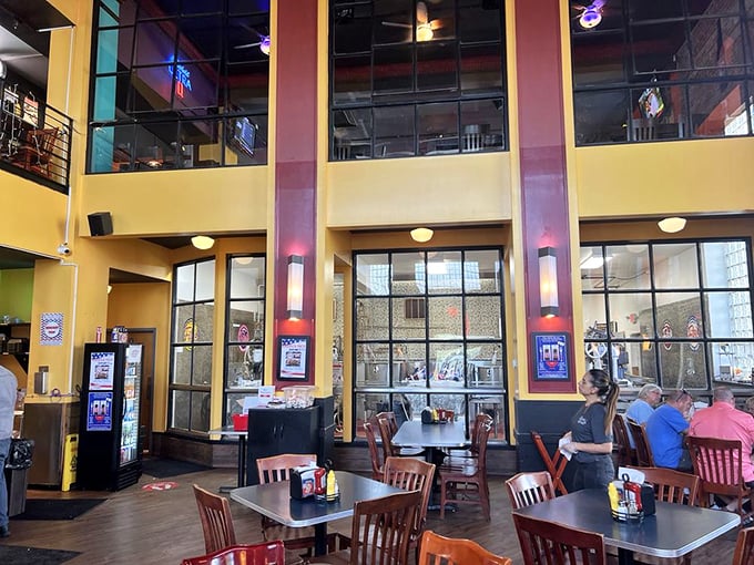 Soaring ceilings and a mezzanine level give the dining room an airy feel, while wooden chairs and tables keep the vibe comfortably casual.
