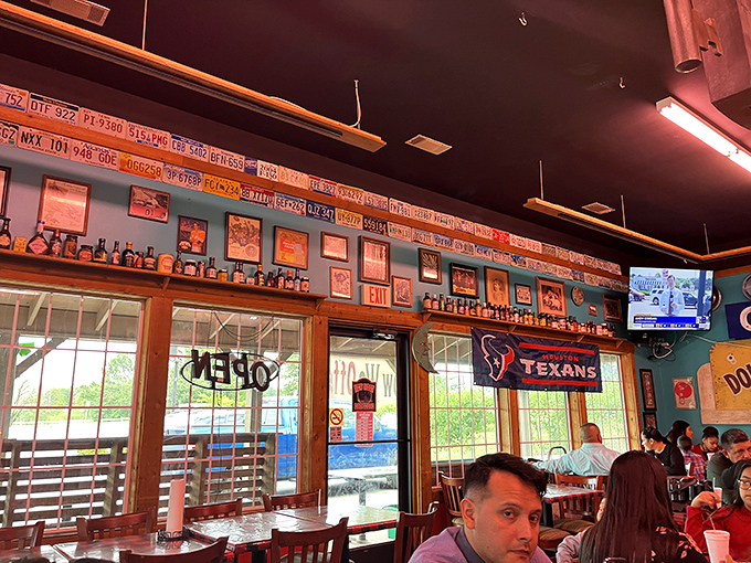 License plates line the walls like badges of honor, telling the story of pilgrims who've traveled far for that perfect barbecue fix.