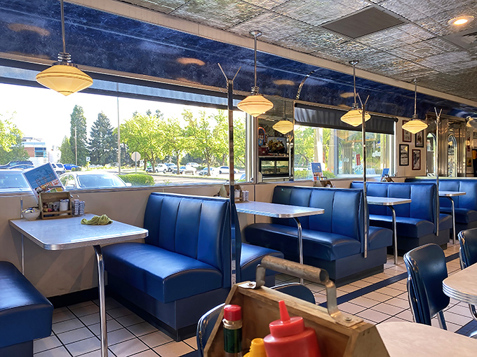Blue vinyl booths and chrome tables: the unofficial living room of America where strangers become neighbors over coffee refills.