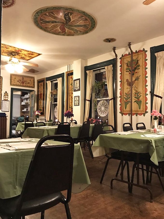 Evening light transforms the dining room into a cozy sanctuary. Those pale green tablecloths have witnessed countless "mmms" and "you've got to try this."