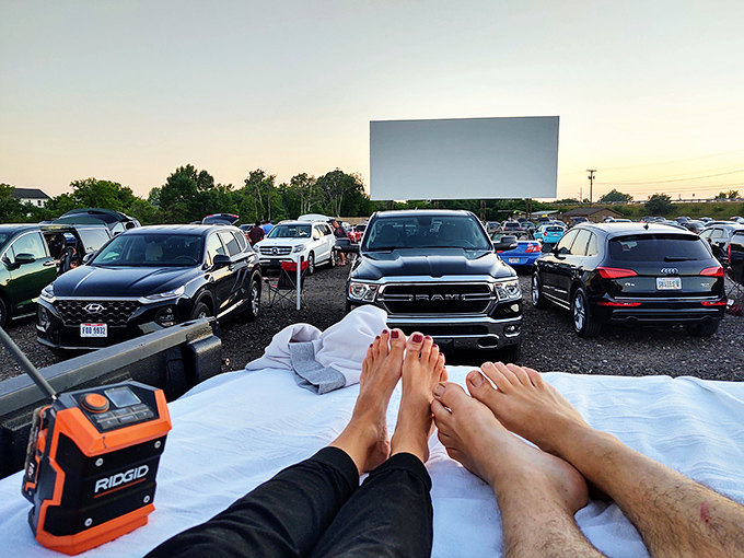 The ultimate drive-in luxury suite: tailgate down, blankets arranged, and nothing between your toes and the silver screen but the cool night air.