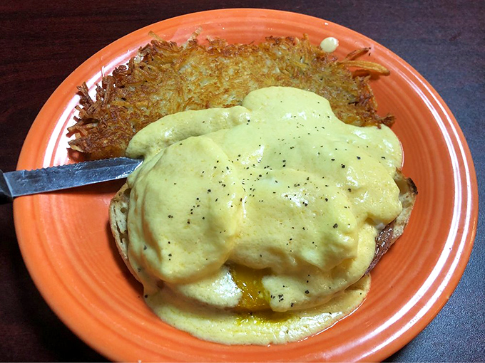 Eggs Benedict with hollandaise that cascades like a yellow waterfall over English muffins &ndash; morning decadence defined.
