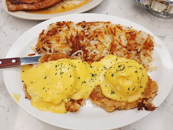 Eggs Benedict that would make a French chef tip his toque. Those hash browns have achieved the perfect crisp-to-tender ratio that science still can't explain.