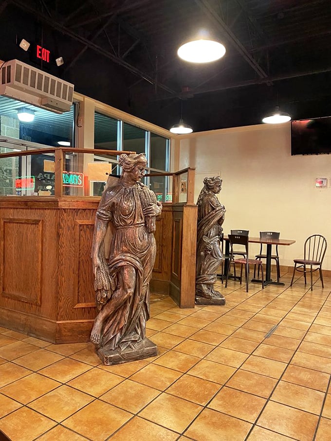 Classical statues stand guard over the pizza paradise. Like ancient sentinels protecting the sacred recipes within.