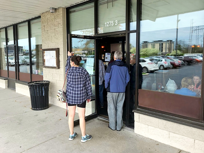 The entrance where hungry patrons gather, knowing good things await inside. That slight wait just builds the anticipation.