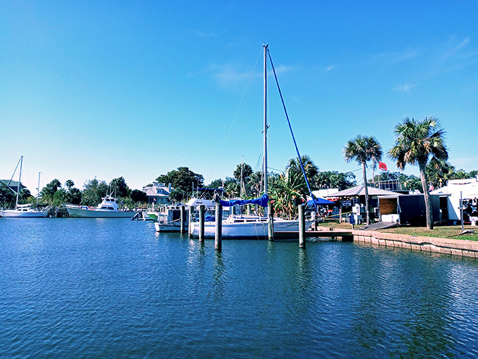 A marina where boats gently bob in crystal blue waters, proving that sometimes the best entertainment is simply watching the world float by.