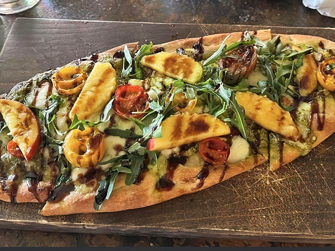 Flatbread that defies gravity with its mountain of toppings. Each bite delivers a perfect ratio of crisp crust to fresh ingredients.