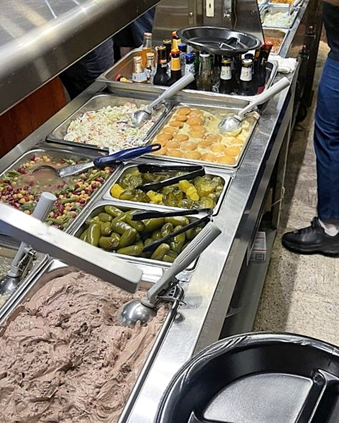 The sides station&mdash;where coleslaw, beans, and pickles patiently wait to complement your meat marathon with tangy, crunchy relief.