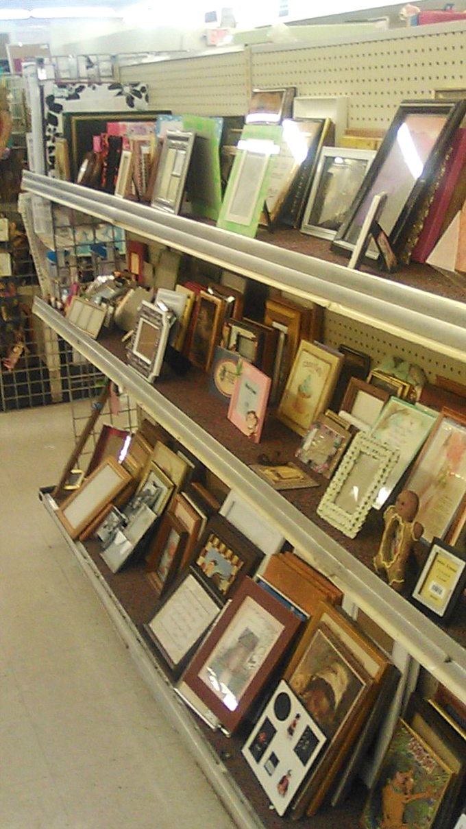 The frame section: where someone else's forgotten family portraits become the perfect housing for your vacation snapshots.