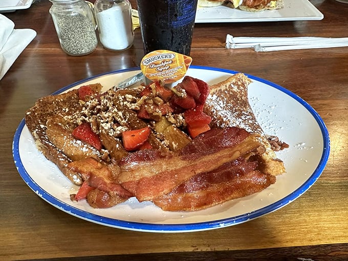 French toast that puts Paris to shame, topped with strawberries and bacon that makes an irresistible sweet-savory duet.