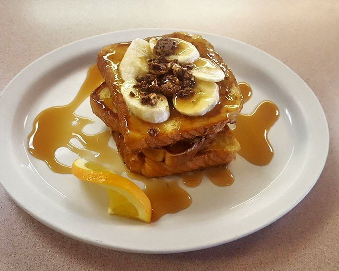 French toast that transcends the ordinary with caramelized bananas and a maple syrup waterfall. Breakfast or dessert? Why choose?