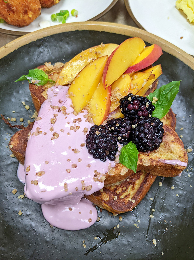 French toast that got all dressed up for the occasion, wearing a berry-pink sauce and accessorized with fresh fruit.