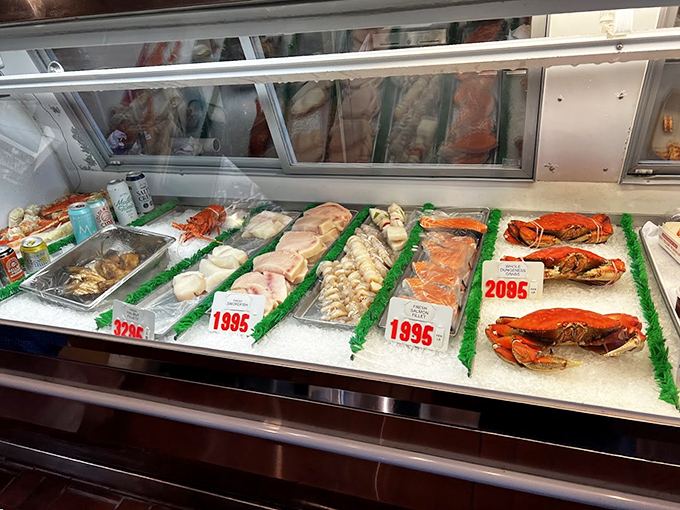 The fish market display case showcases ocean treasures on beds of ice, a reminder that at The Crab Cooker, "fresh" isn't just marketing &ndash; it's the foundation of everything they serve.
