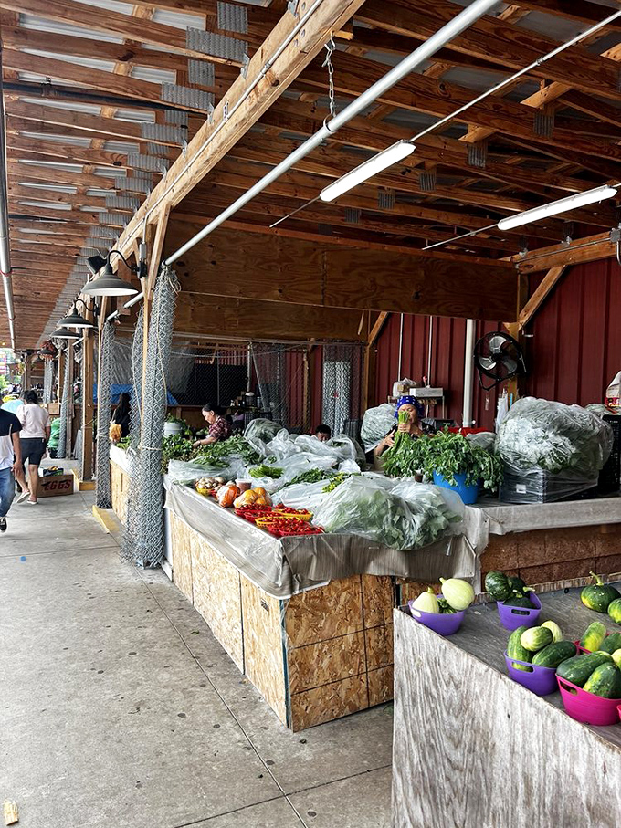 Farm-fresh produce displayed under rustic wooden beams. These vegetables didn't travel further to get here than you did&mdash;the definition of local bounty.