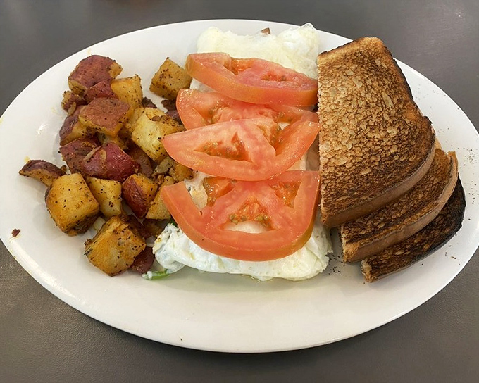 An omelet that's clearly been to the farmers market and brought back souvenirs. Those tomatoes are practically sunbathing on a bed of perfectly cooked eggs.