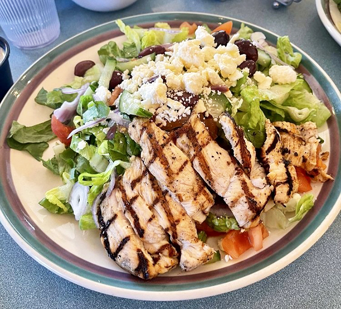 A Greek salad that brings Mediterranean sunshine to Wisconsin, topped with grilled chicken that's clearly been introduced to actual fire.