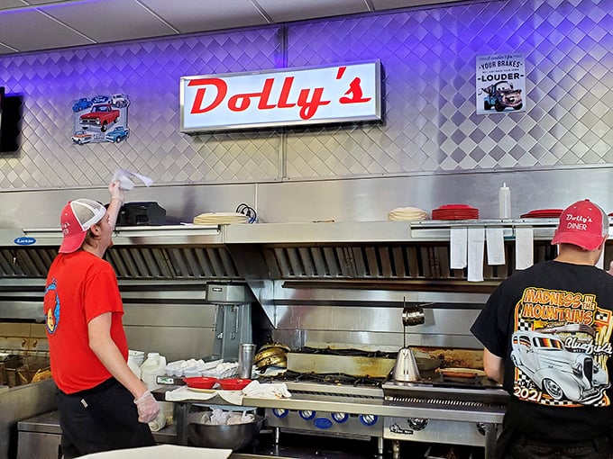 The grill masters of Dolly's perform their daily ritual, transforming simple ingredients into the comfort food equivalent of a warm hug.