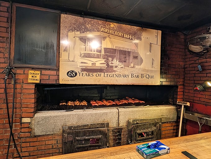 The pit&mdash;where magic happens at 225 degrees. That "Danger: Men Cooking" sign isn't just cute; it's a fair warning.