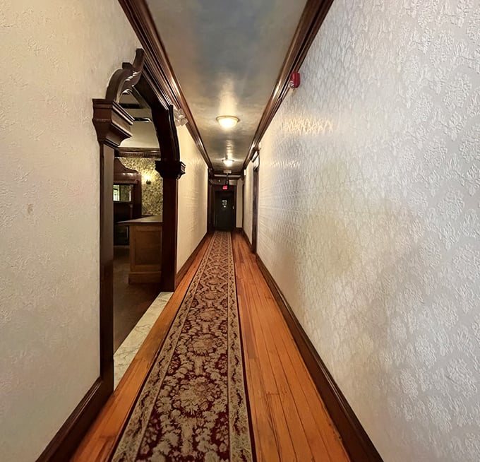 The hallway's vintage charm hints at the building's history&mdash;wooden floors and ornate runner creating a pathway to dining satisfaction.