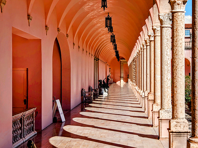 The mansion's covered walkway creates a rhythm of light and shadow that's hypnotic&mdash;architecture that's both shelter and visual poetry.