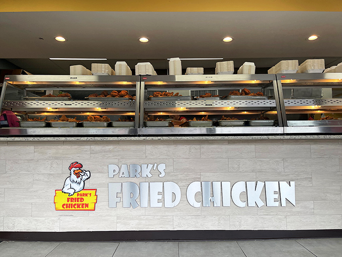 Behind this counter, magic happens. The Park's logo promises fried chicken excellence while the warming trays deliver on that promise.