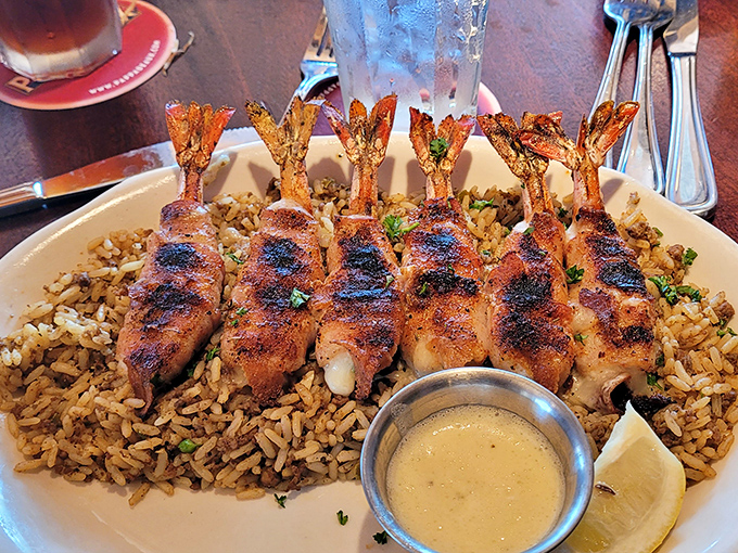 Jumbo Shrimp Brochette&mdash;bacon-wrapped treasures from the sea atop dirty rice. A dish so good it deserves its own thank-you note.