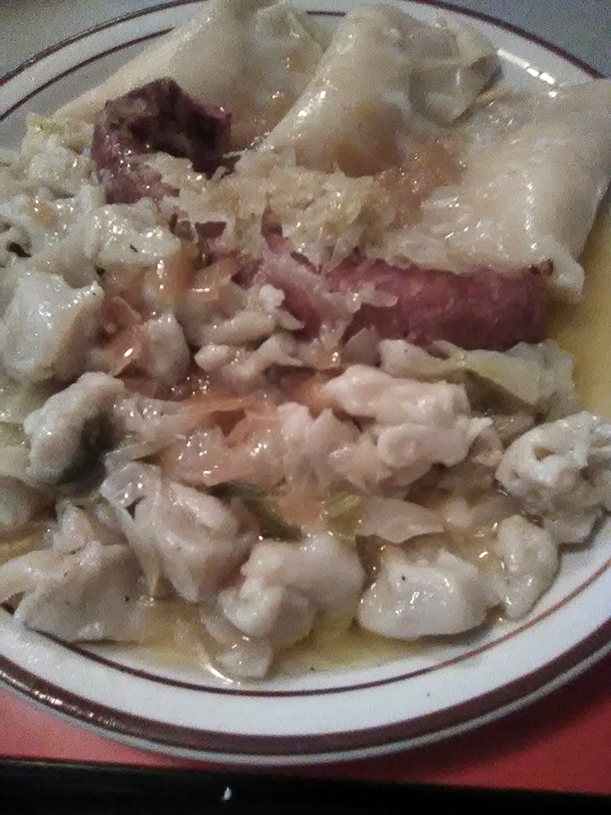 Tender dumplings swimming alongside kielbasa in a buttery broth—proof that sometimes the simplest combinations create the most profound flavors.